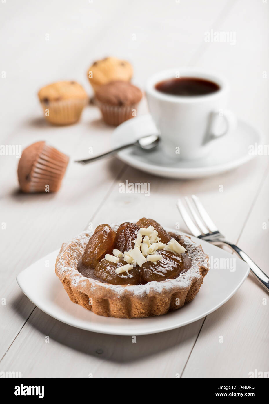 chestnut cake decorated with white chocolate and cup of coffee on ...
