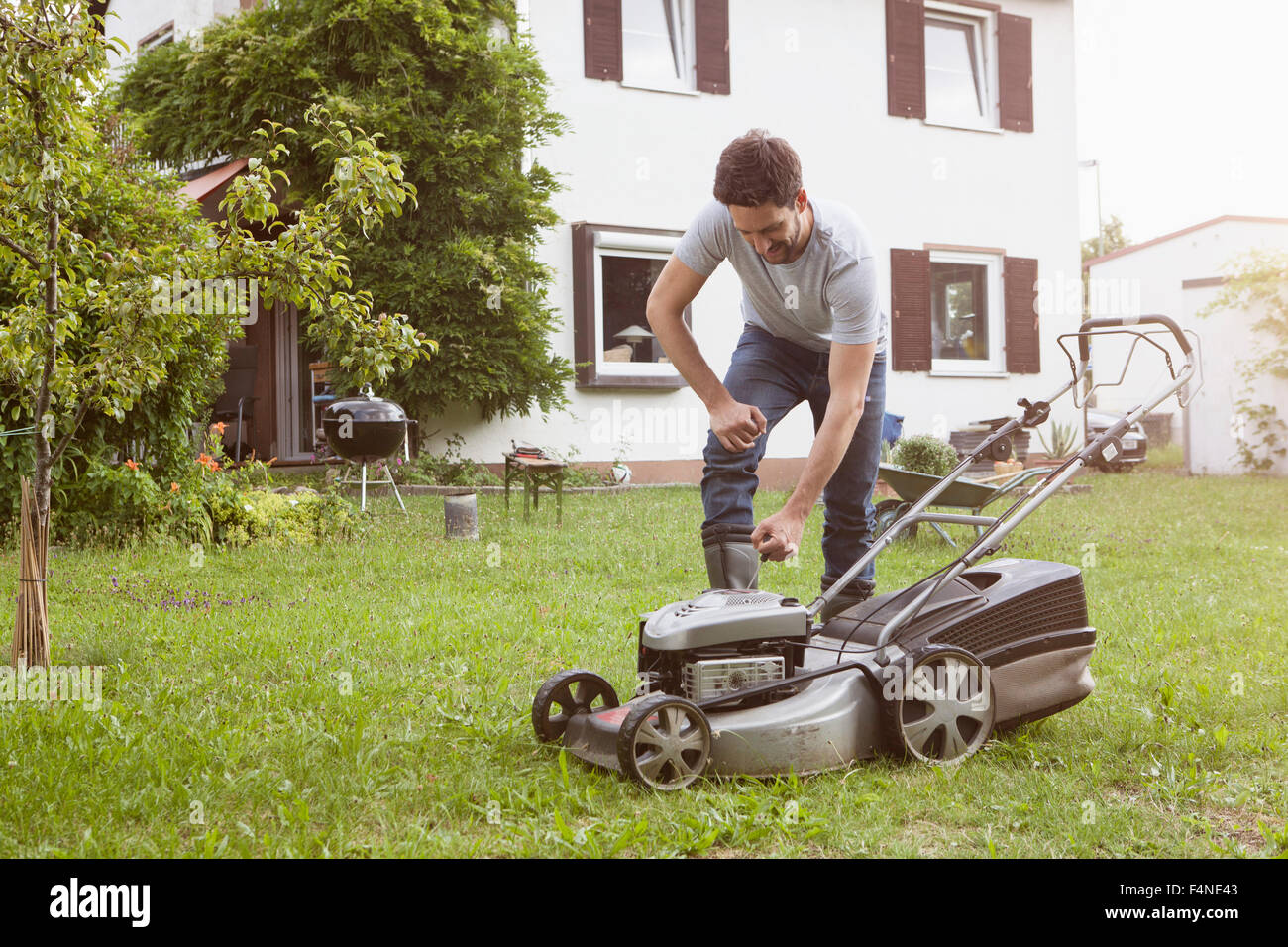 Men mowing hi-res stock photography and images - Alamy