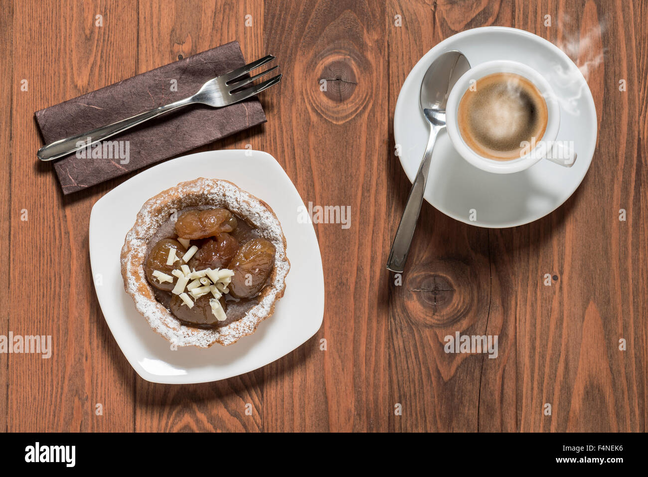 chestnut cake decorated with white chocolate and cup of coffee on ...