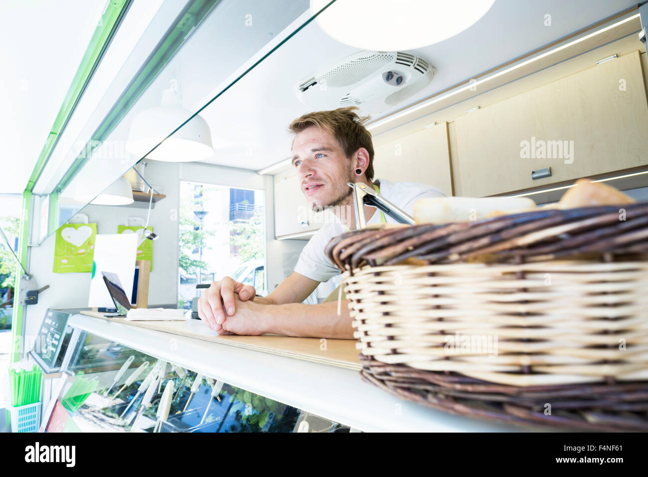 Seller in a food stall waiting for customers Stock Photo - Alamy