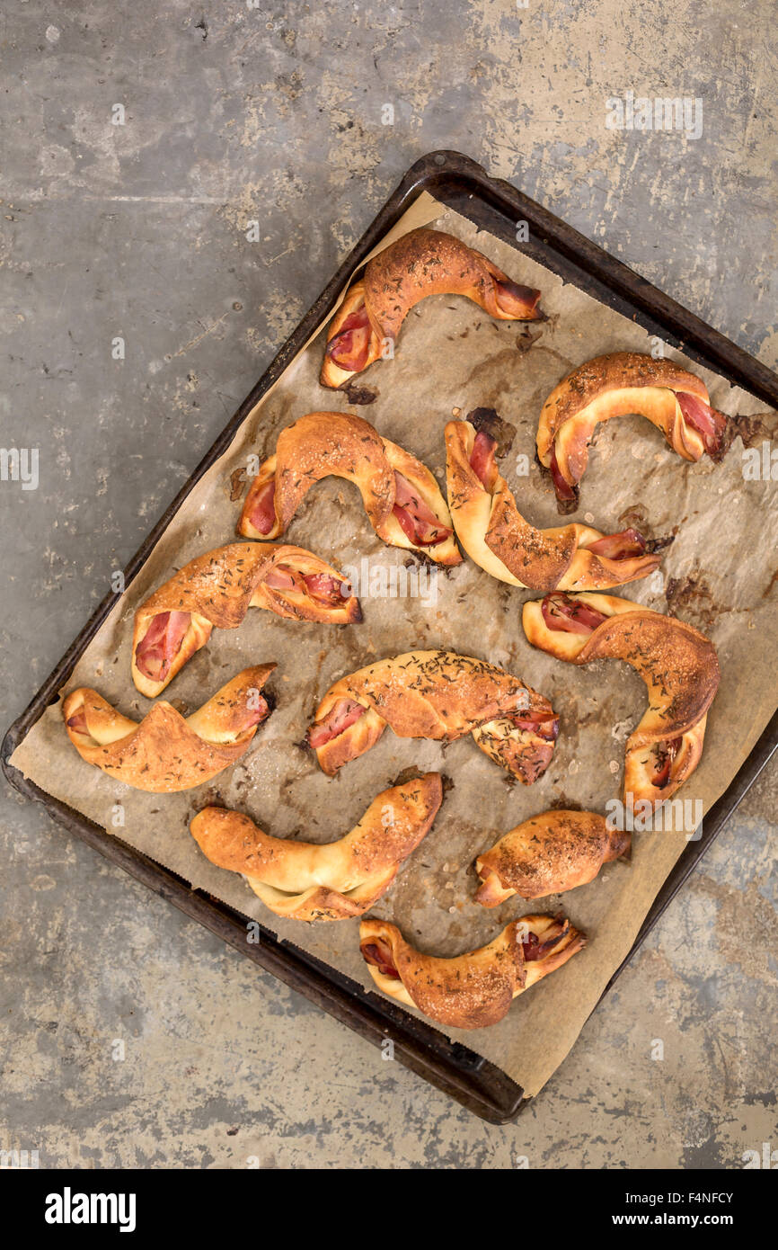 Raised pastry with caraway and bacon on baking tray Stock Photo - Alamy