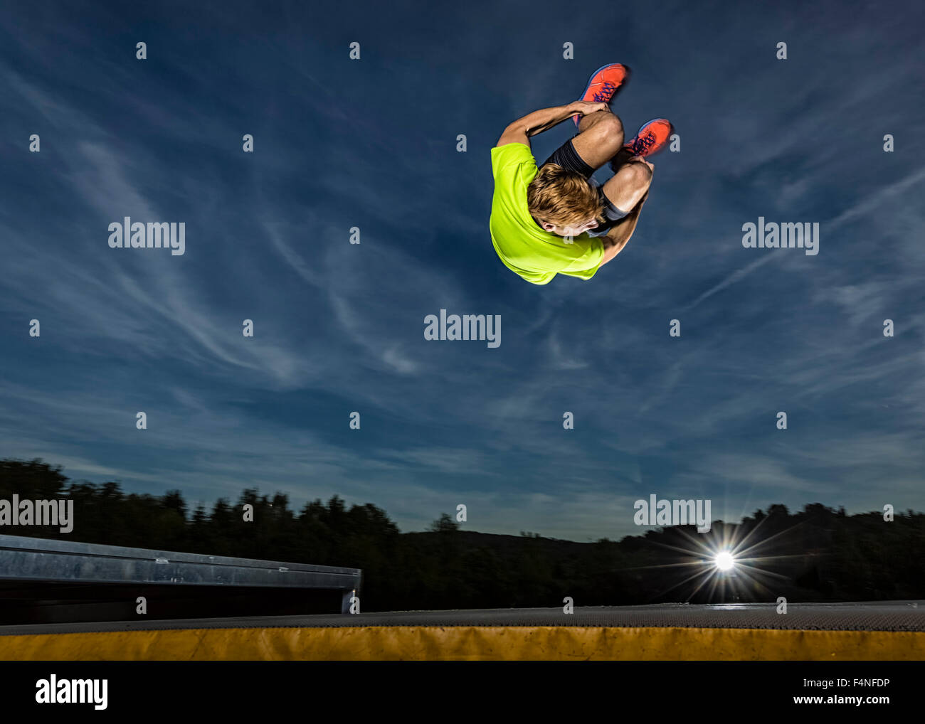 Young man doing somersault Stock Photo - Alamy