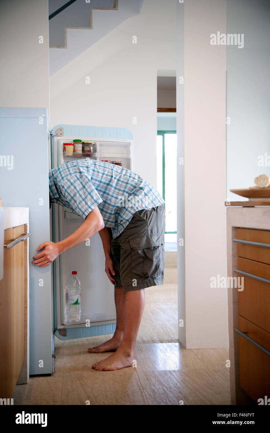 Young man fridge opening hi-res stock photography and images - Alamy