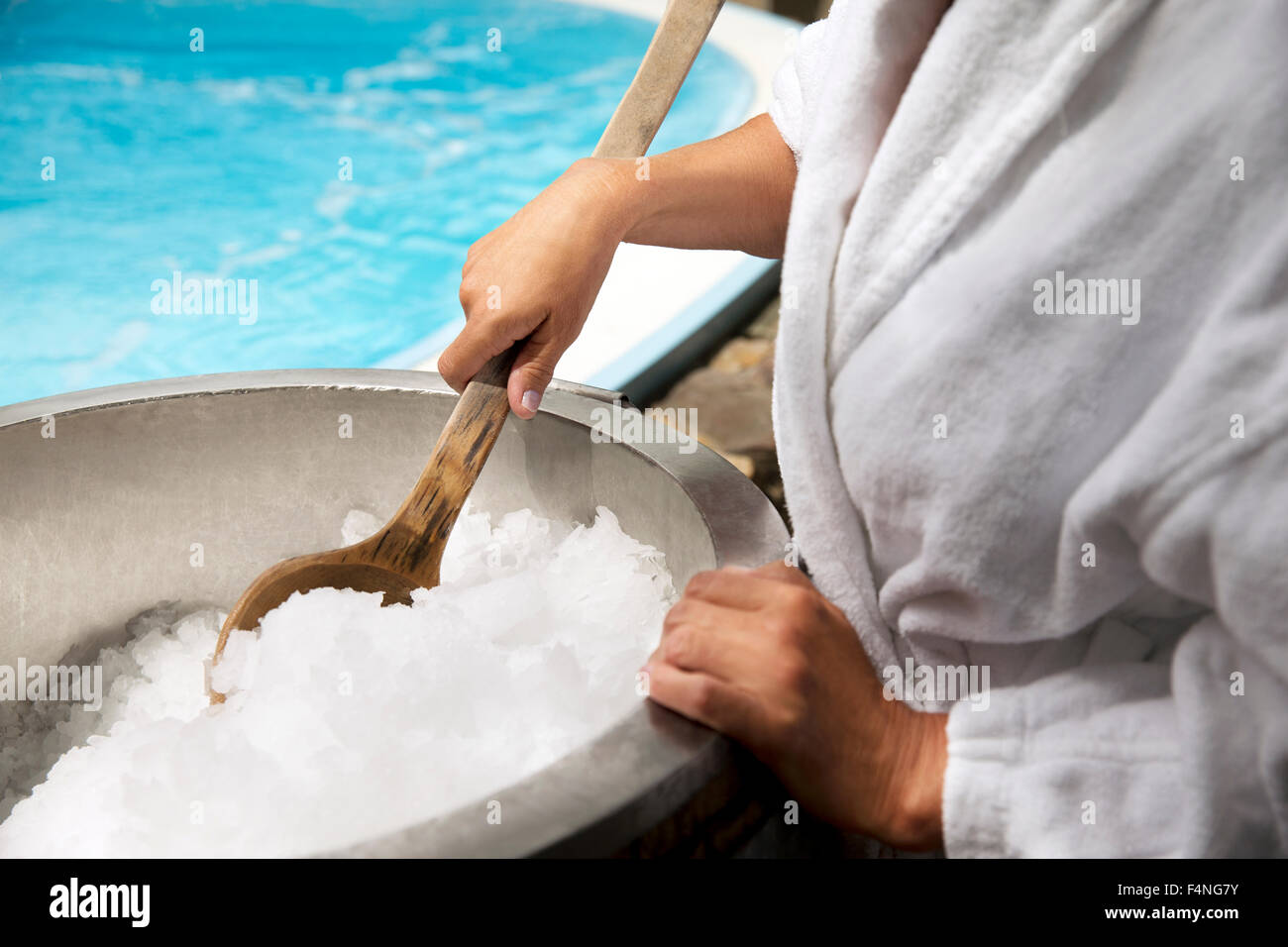 Woman with wooden spoon in ice bucket in a spa Stock Photo - Alamy