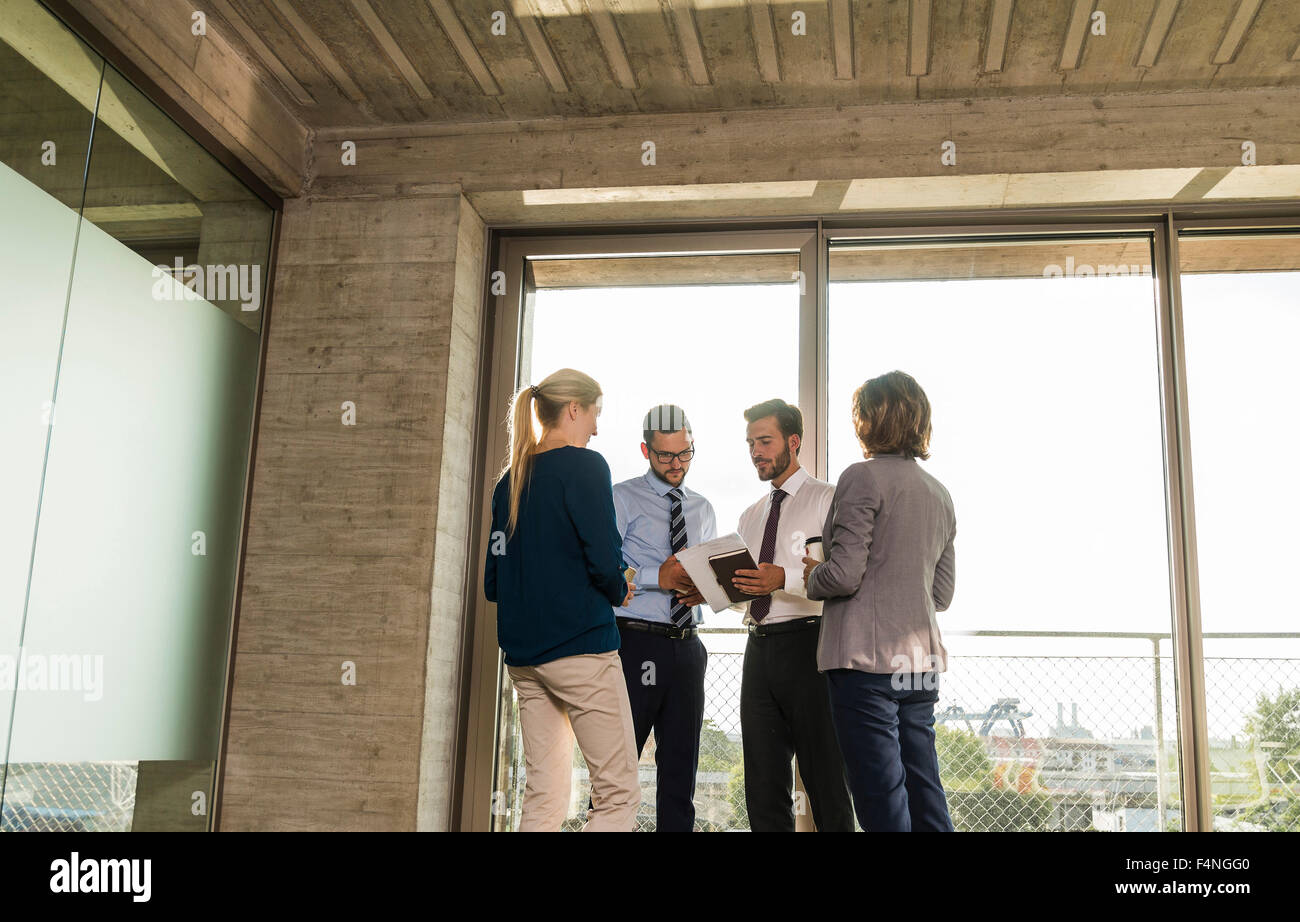 Business people talking at the window Stock Photo - Alamy