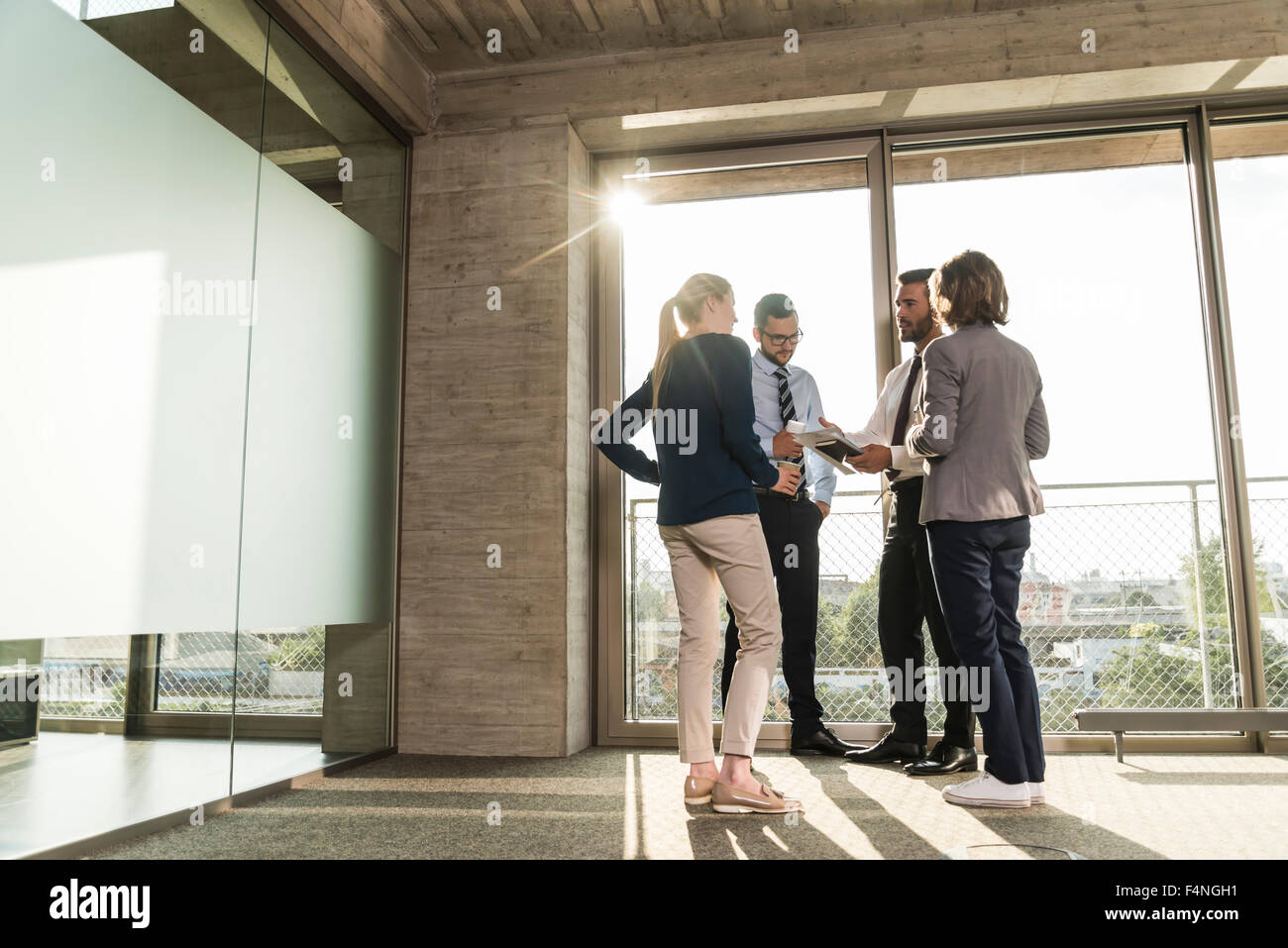 Business people talking at the window Stock Photo - Alamy