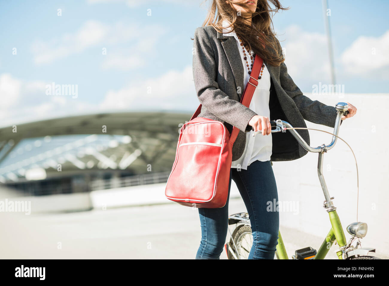 Young woman pushing bicycle Stock Photo - Alamy