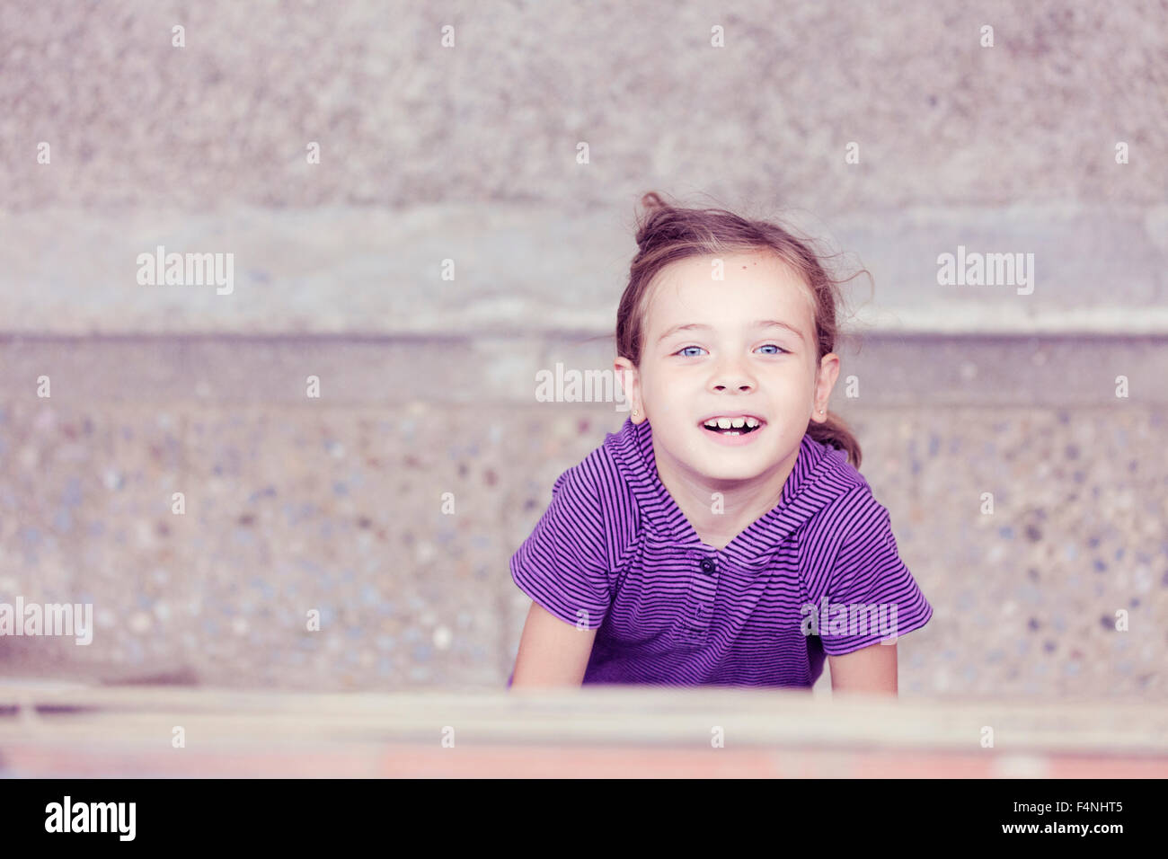 Portrait of little girl looking up to the camera Stock Photo - Alamy