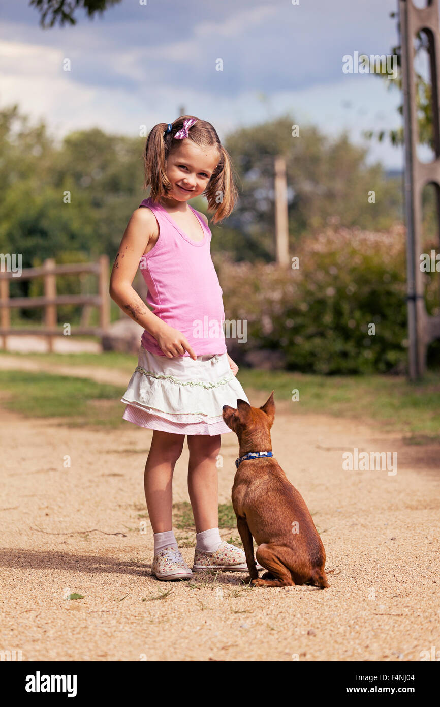 Portrait of smiling little girl with her dog Stock Photo - Alamy
