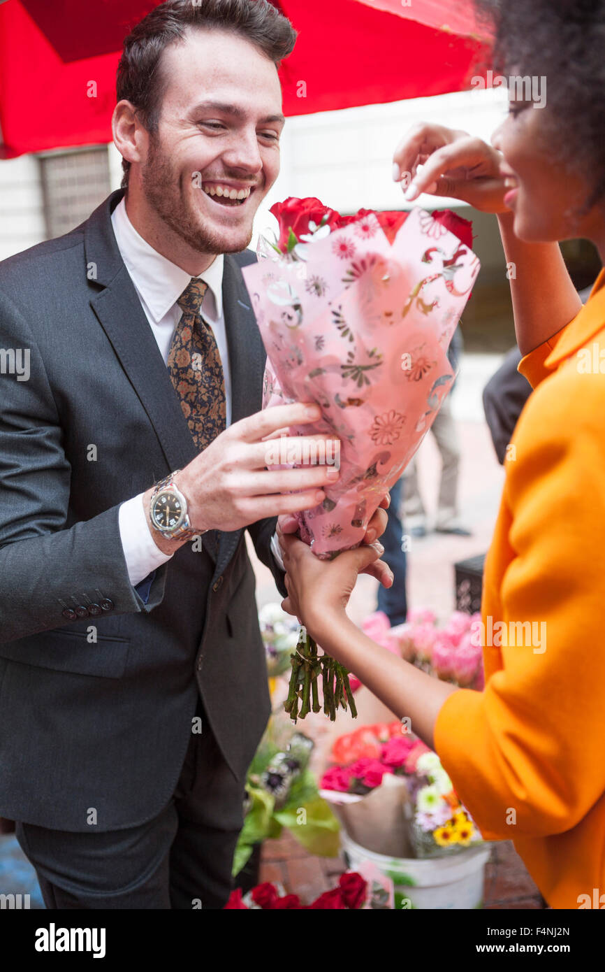 Woman receiving red roses hi-res stock photography and images - Alamy