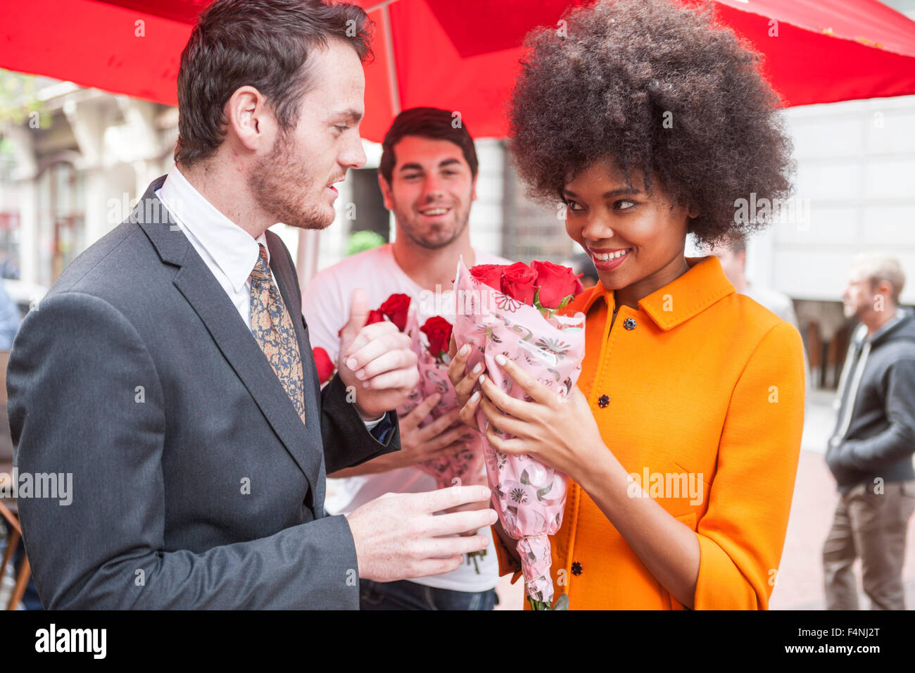 Woman receiving red roses hi-res stock photography and images - Alamy