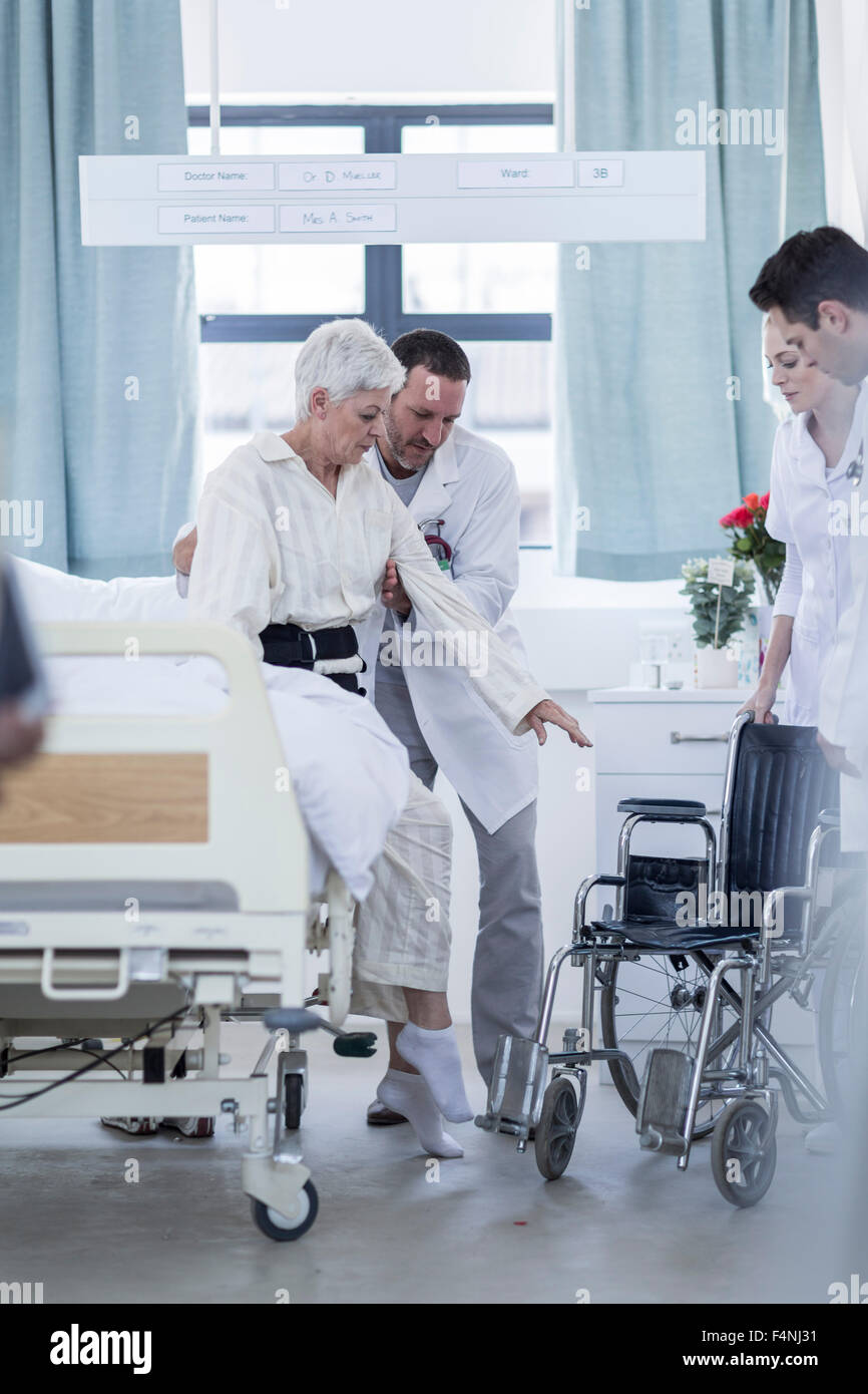 Doctor and staff helping patient with wheelchair in hospital Stock ...