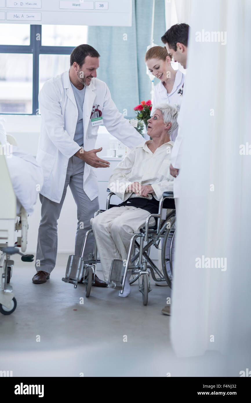 Doctor and staff helping patient with wheelchair in hospital Stock ...