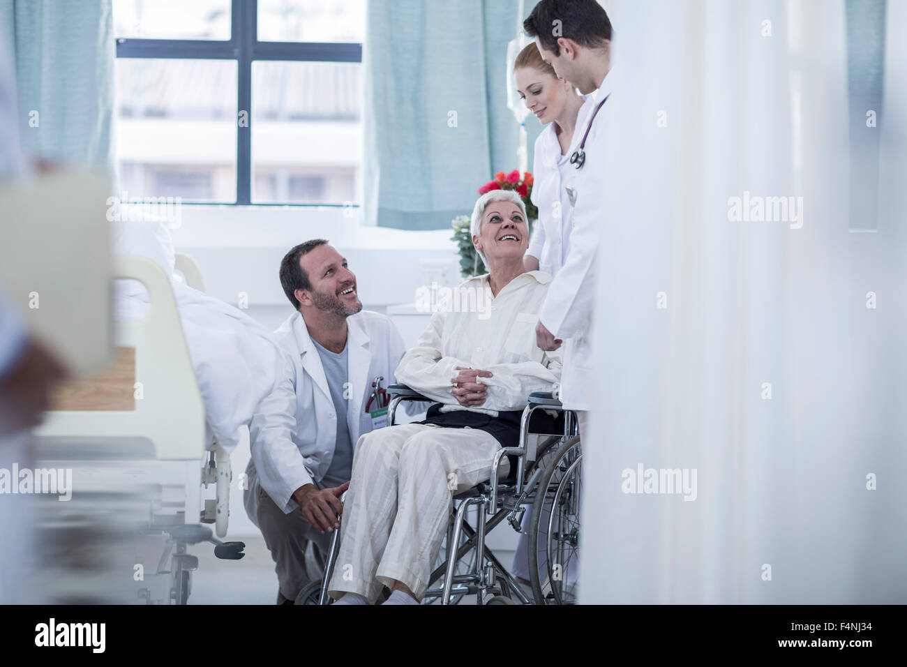 Doctor and staff helping patient with wheelchair in hospital Stock ...