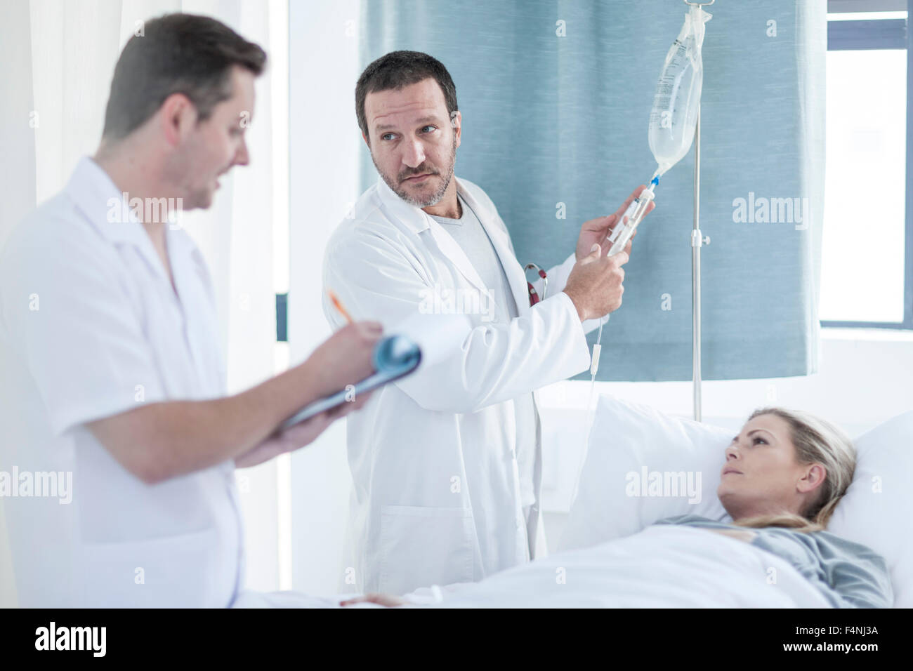 Doctor's checking on patient in hospital Stock Photo - Alamy