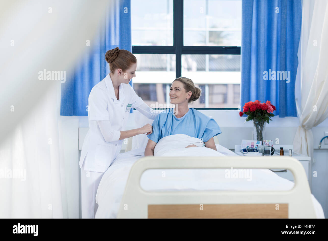 Nurse helping patient in hospital Stock Photo - Alamy