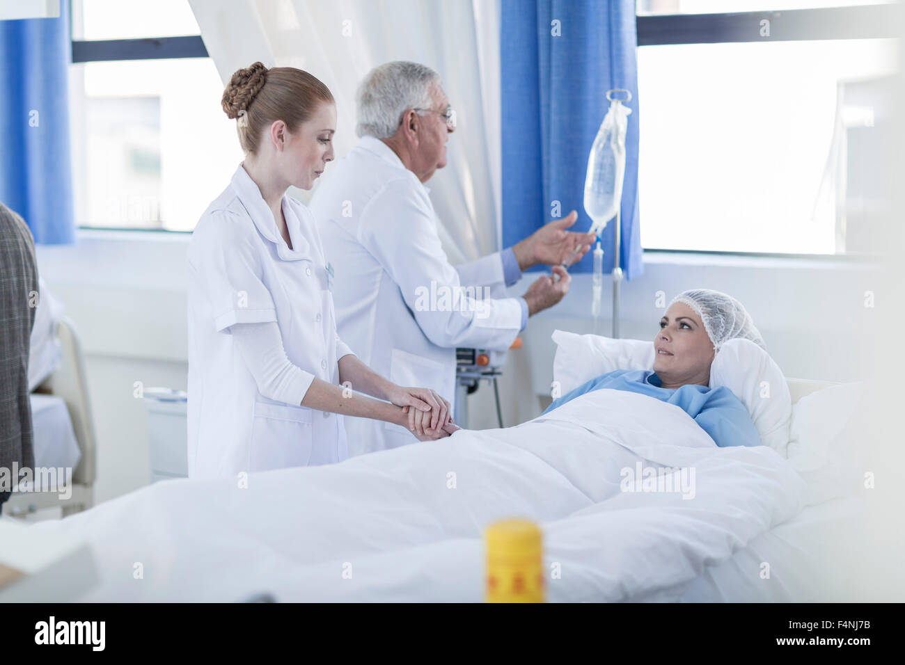 Doctor and nurse at very sick patient's bed in hospital Stock Photo - Alamy
