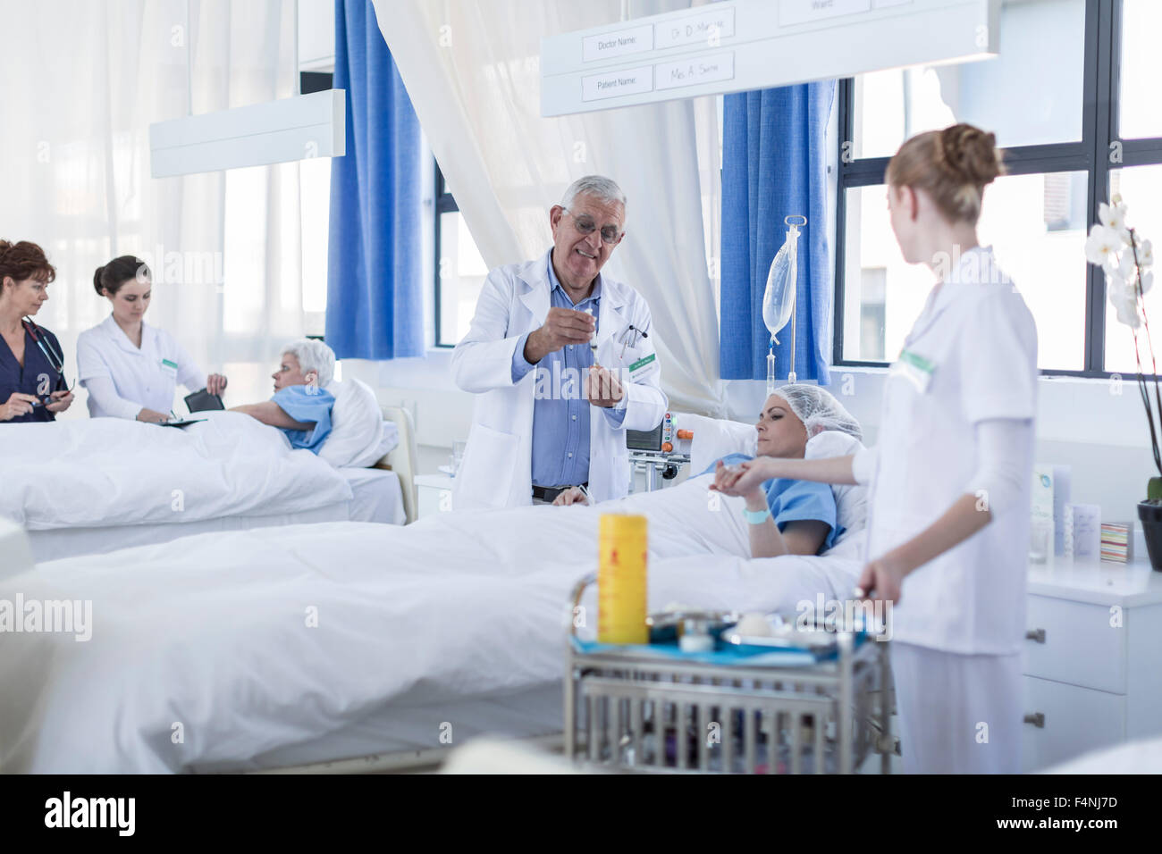 Doctor and nurse at very sick patient's bed in hospital Stock Photo - Alamy