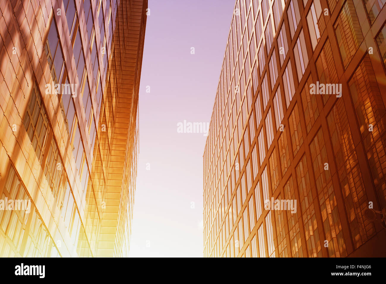 Sun shining between two modern office buildings Stock Photo - Alamy