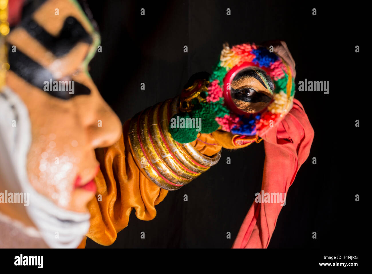 A Katakali artist is checking his make up of the character Shiva for ...