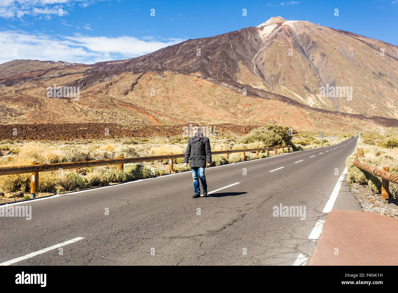 Man walking in a road Stock Photo - Alamy
