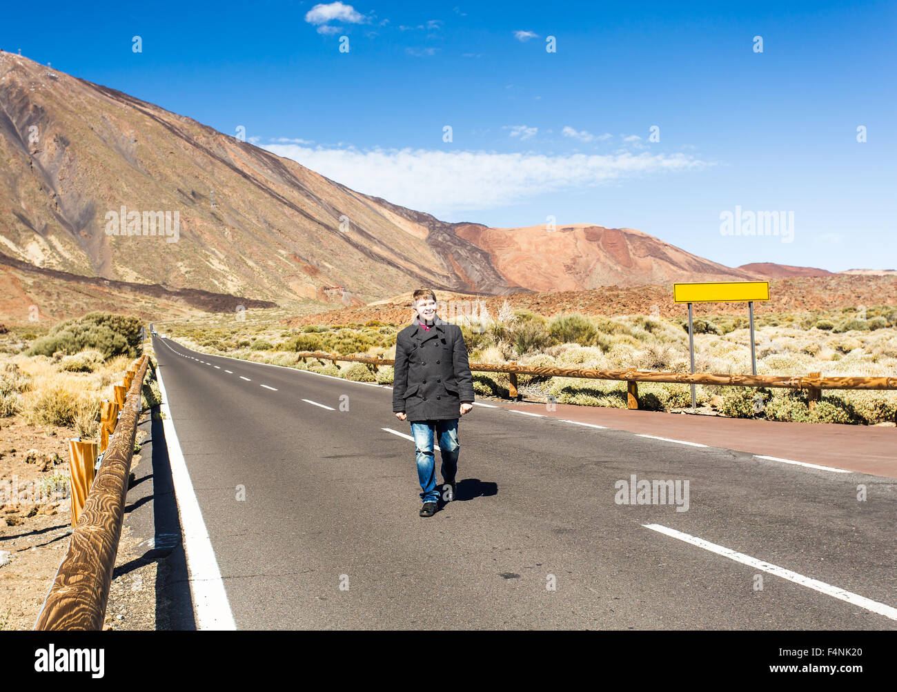 Man walking in a road Stock Photo - Alamy