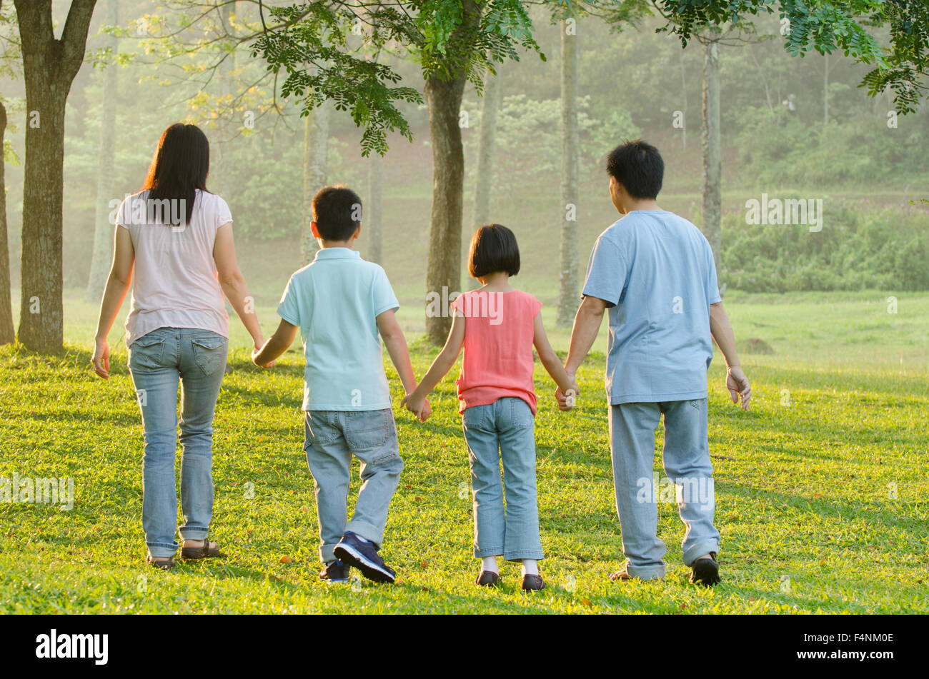 Happy Asian family walking Stock Photo - Alamy