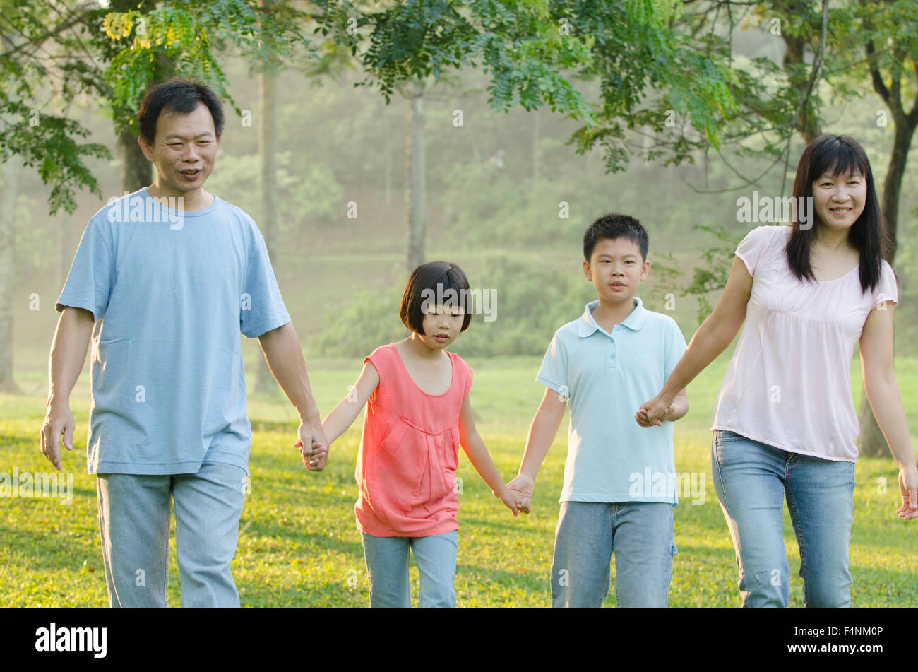 Happy Asian family walking Stock Photo - Alamy