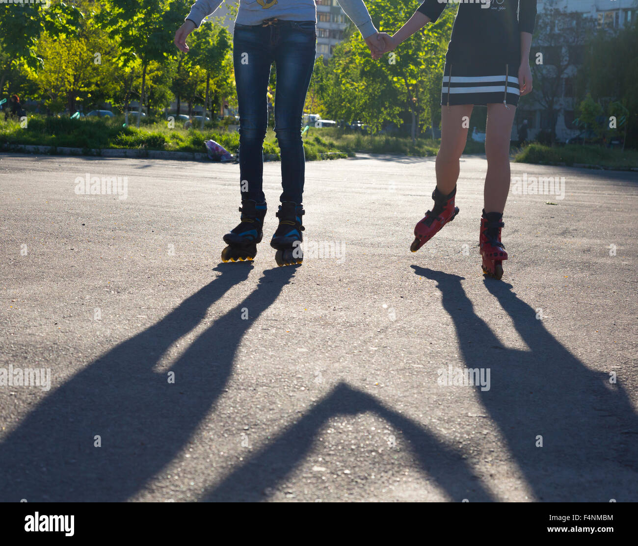 Female roller skaters holding hands Stock Photo - Alamy