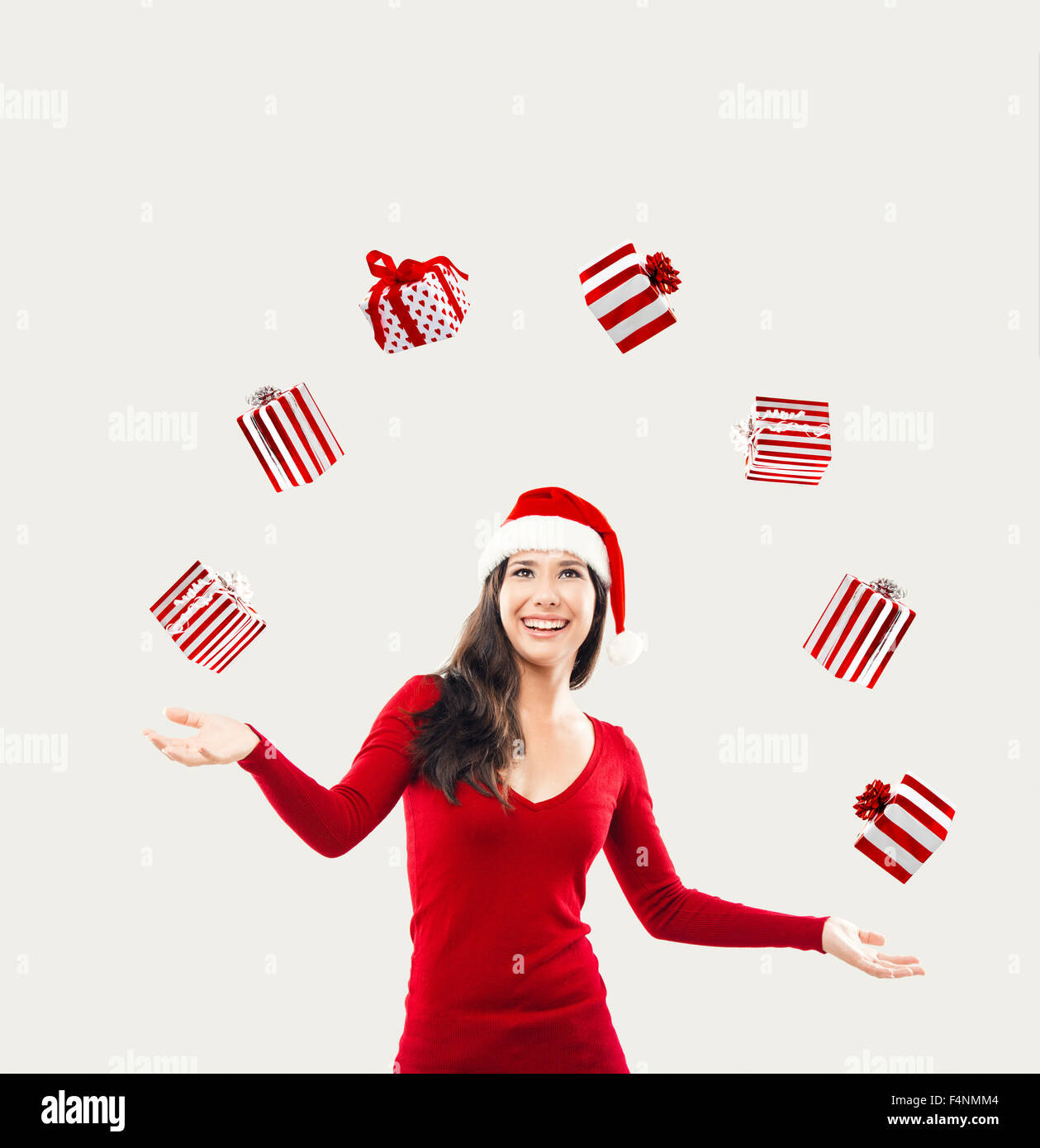 A beautiful woman juggling gifts on the air in a white background Stock ...