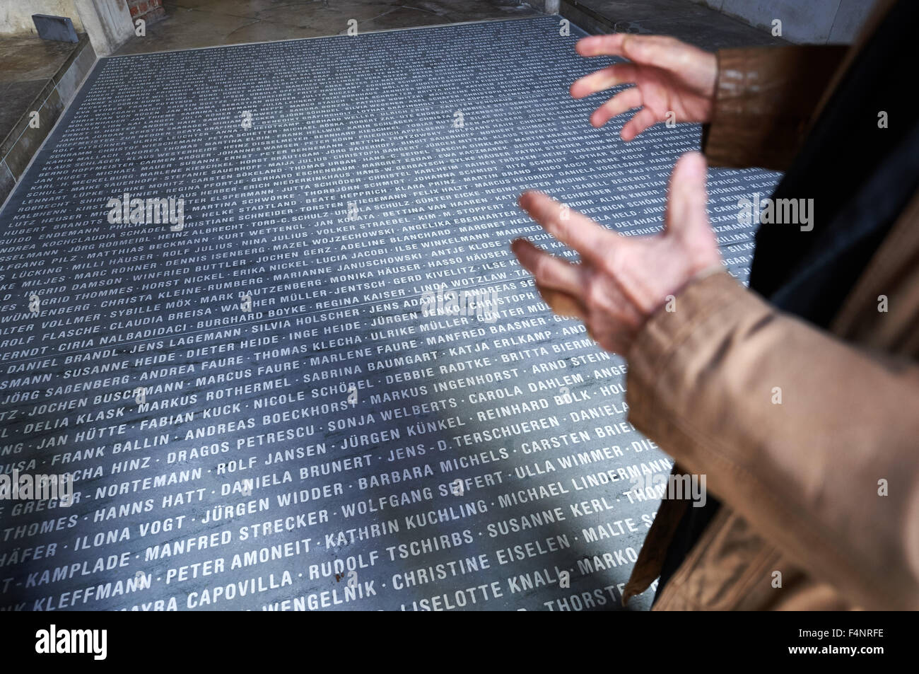 Conceptual artist Jochen Gerz speaks by a flagstone engraved with the ...