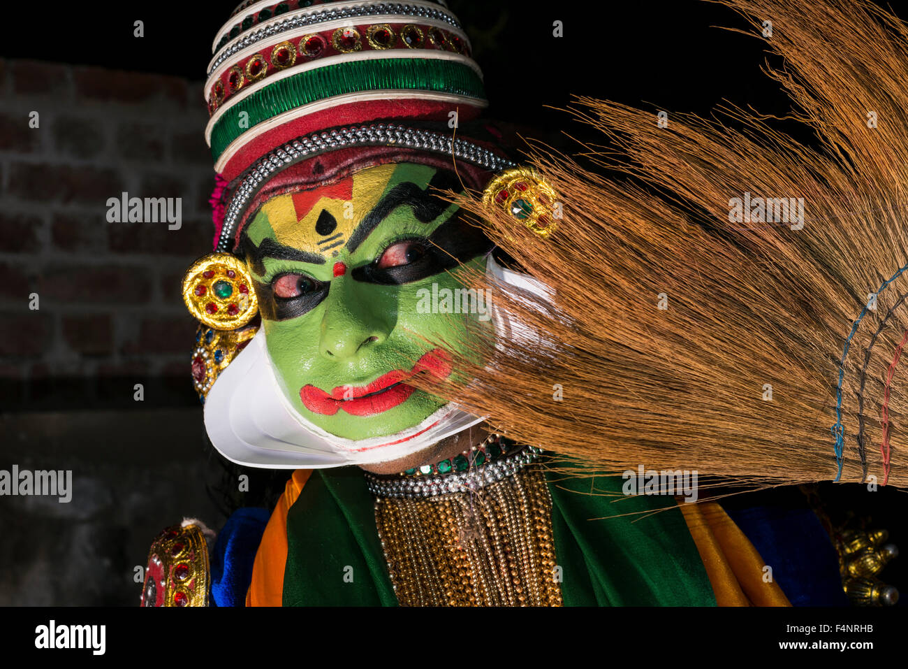 A Katakali artist is posing with the complete make up of the character ...