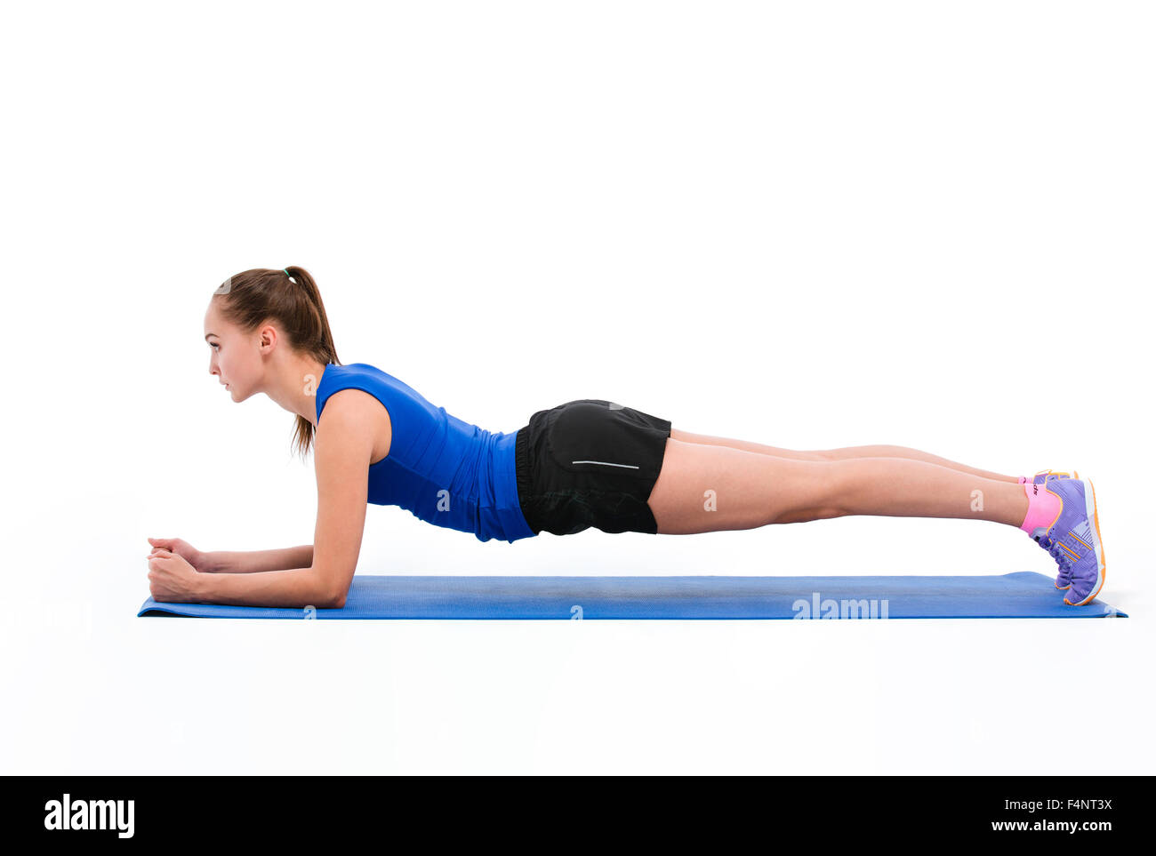 Portrait of a fitness woman doing plank exerises isolated on a white ...