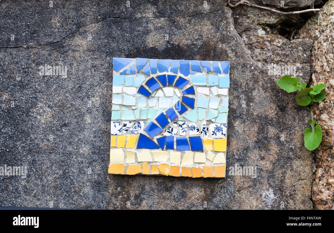 The number 2 or two in colourful blue and yellow mosaic tiles on a wall ...