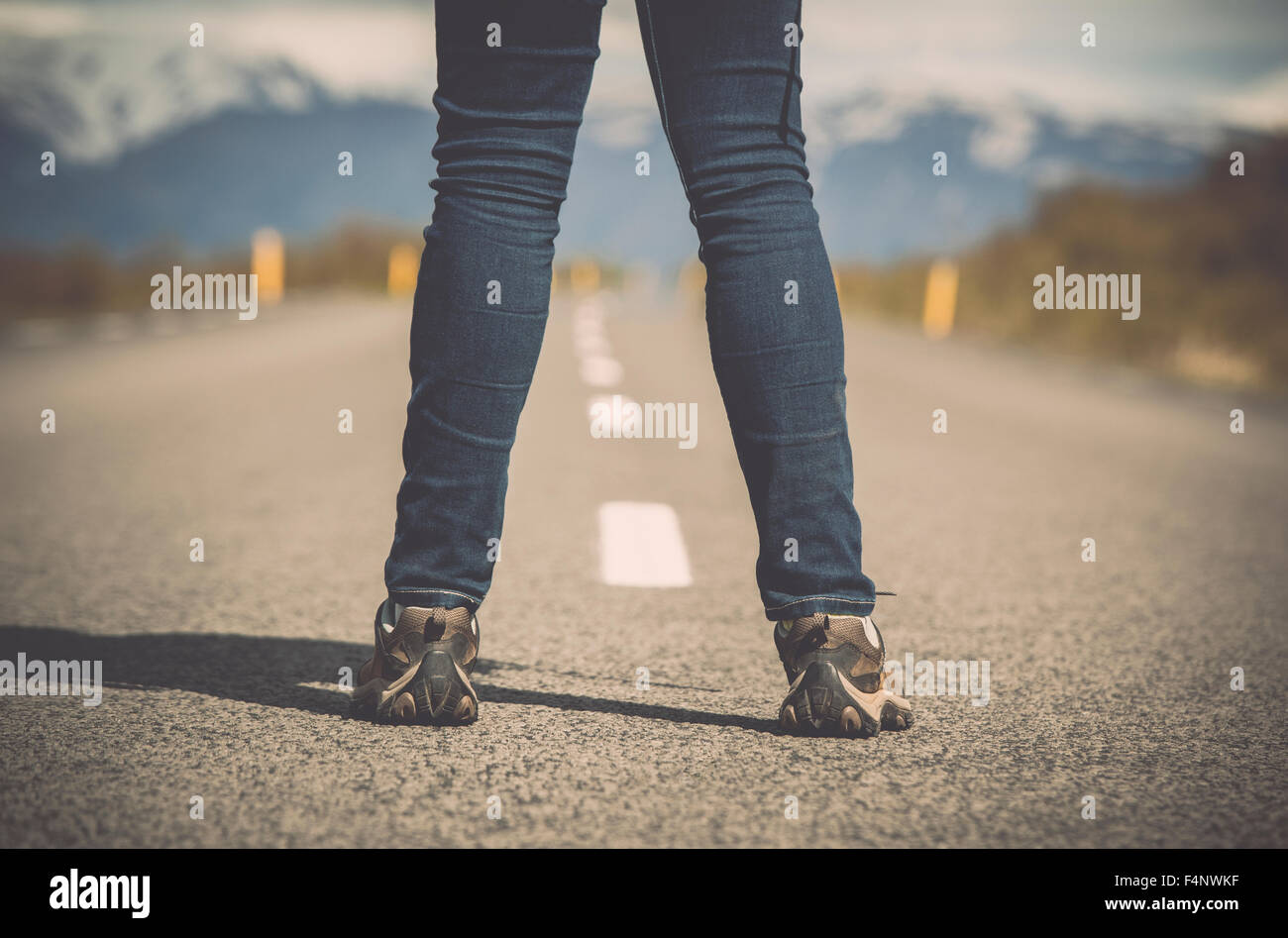 Shoot of a female legs in the center of a road Stock Photo - Alamy