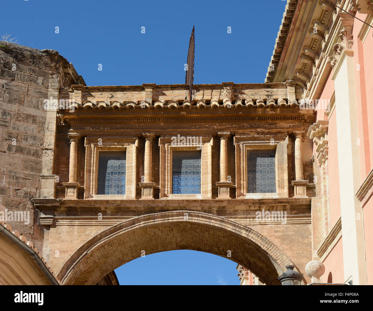 Archway bridge between two buildings in the old city of Valencia. Spain ...