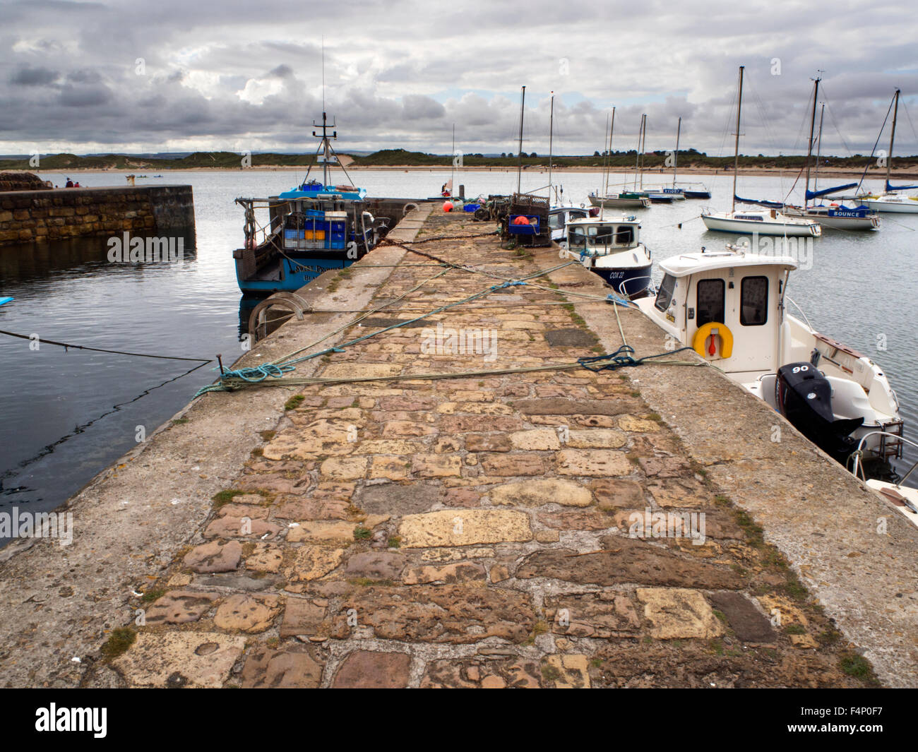 Pier and Boats at the Harbour in Beadnell Northumberland England Stock ...