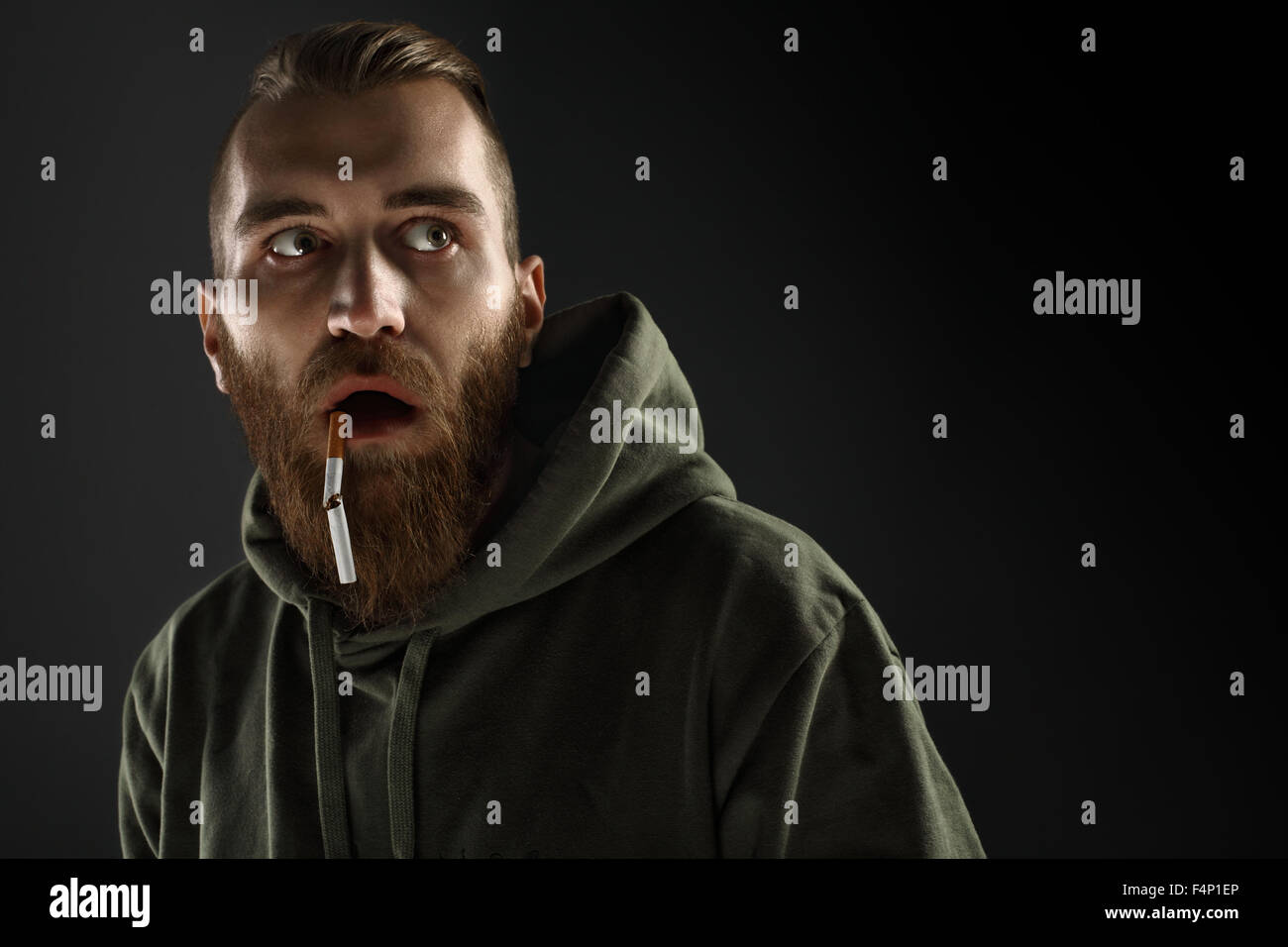Close up portrait of young attractive man breaking down cigarette to ...