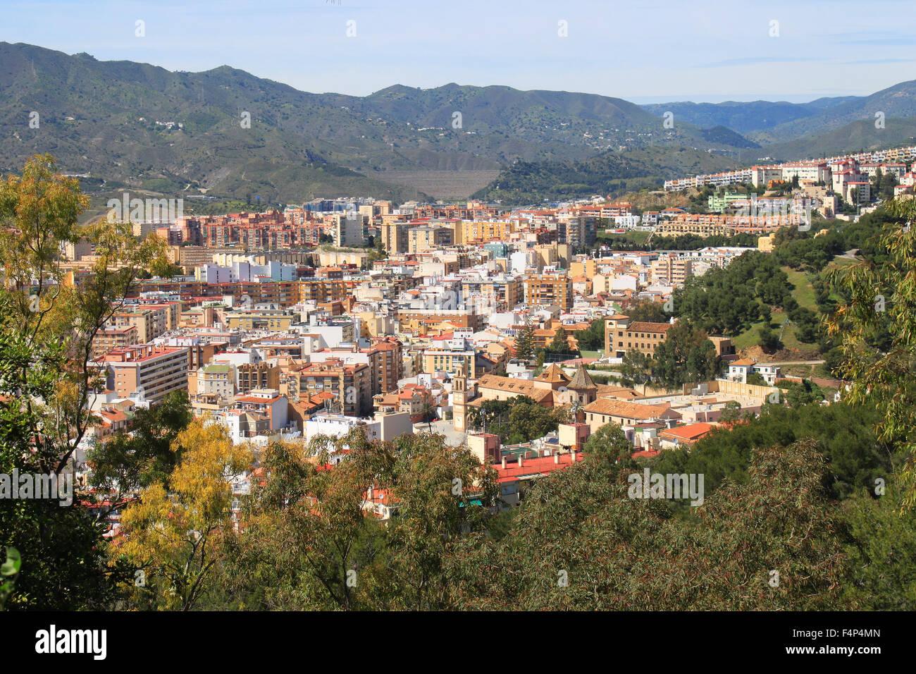 View of Malaga Spain, with mountains in the back and trees in front ...