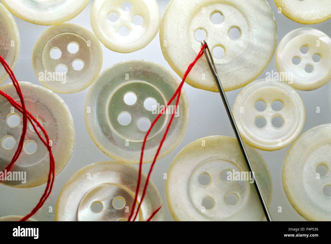 Needle and thread and buttons hi-res stock photography and images - Alamy