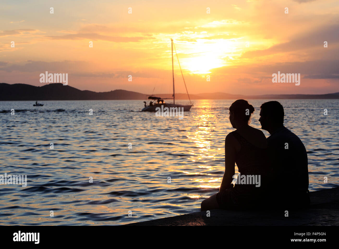 Two lovers enjoying the sunset in Zadar, Croatia Stock Photo - Alamy