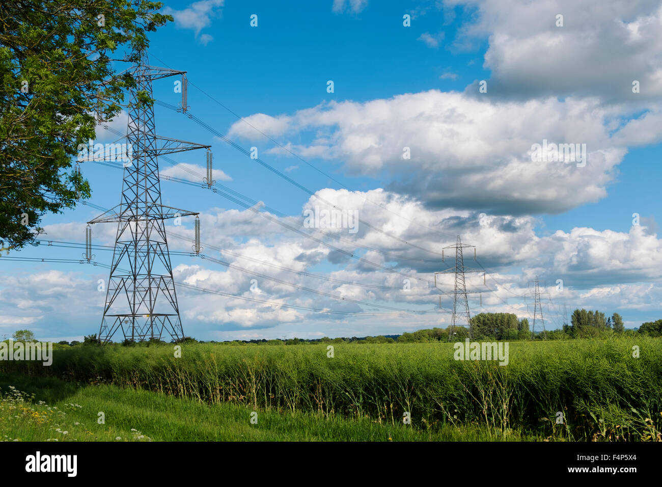 Pylon carrying electricity cables over the countryside in the Cotswolds ...