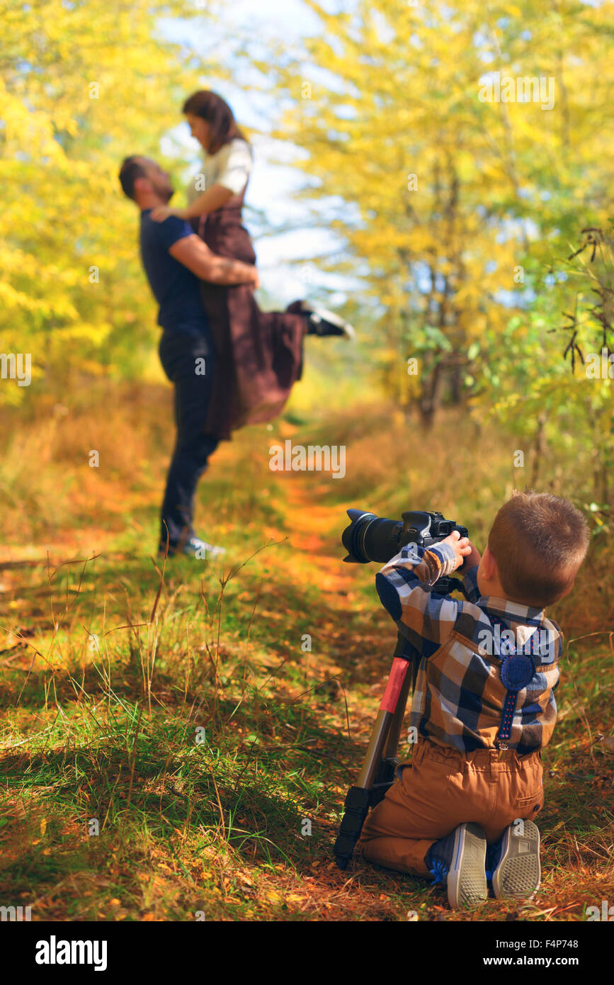 Little kid taking pictures to his parents Stock Photo - Alamy