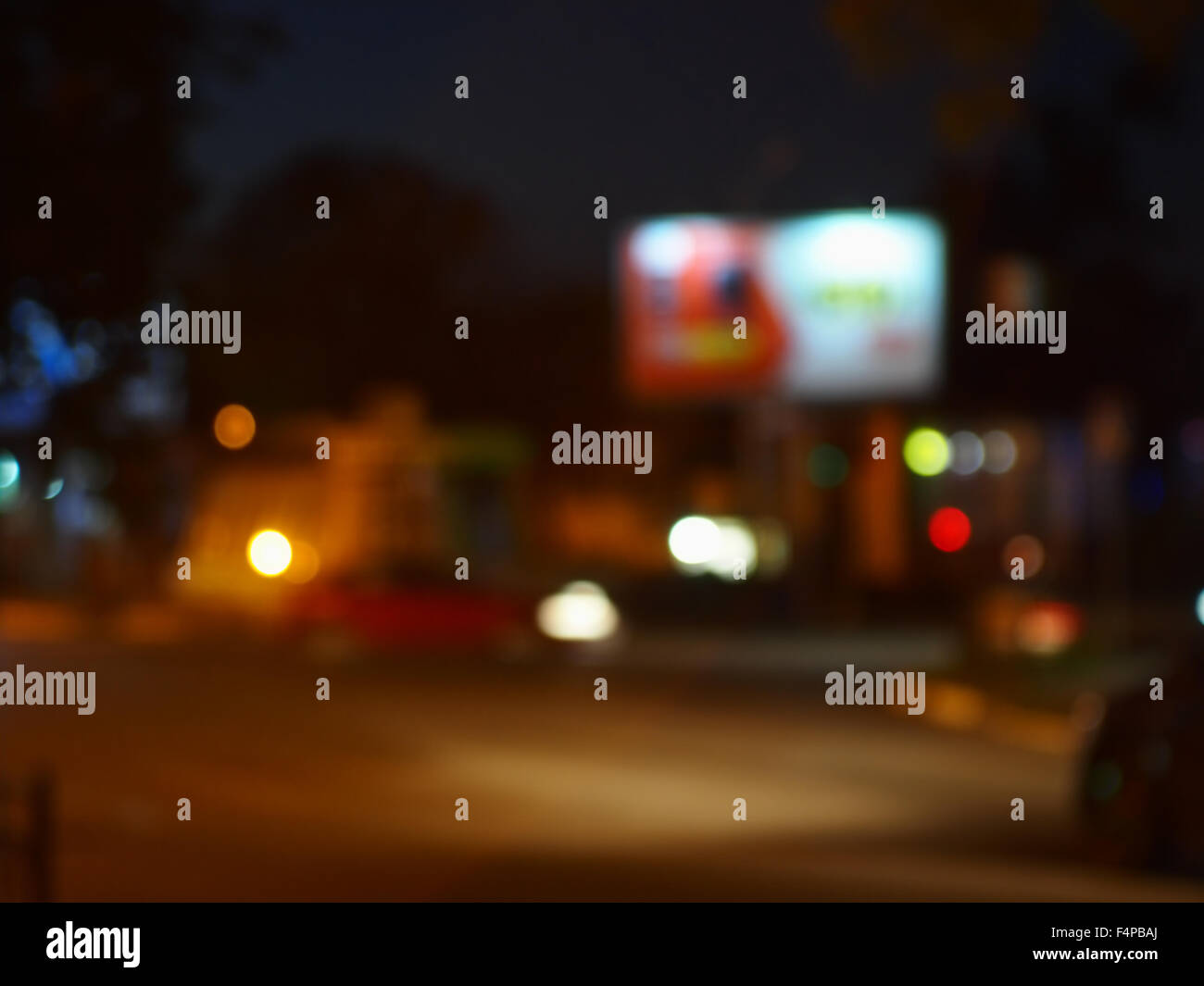 Abstract night scene with dim lights and headlights. Blur and defocused ...