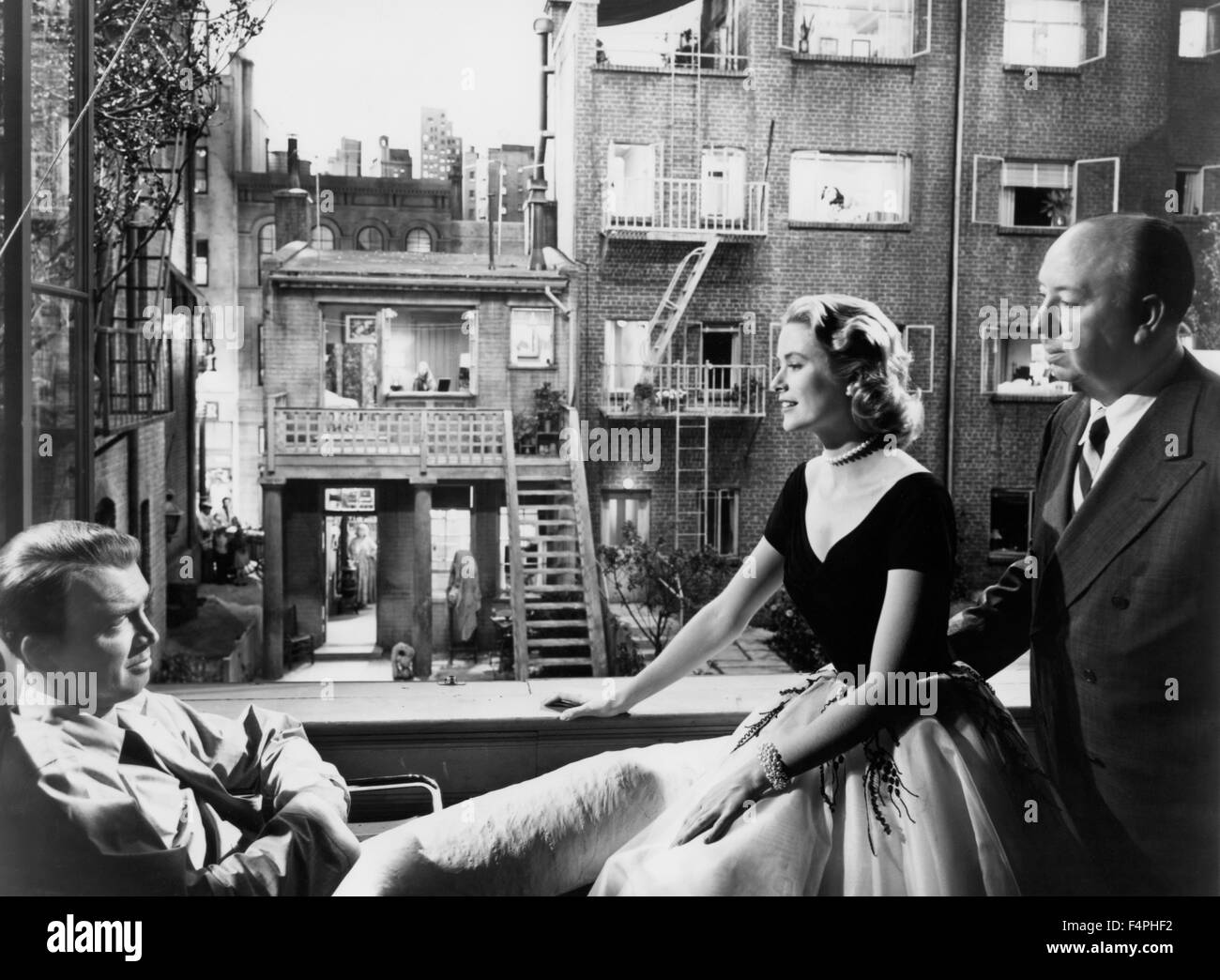 On the set, Grace Kelly between James Stewart and Alfred Hitchcock ...