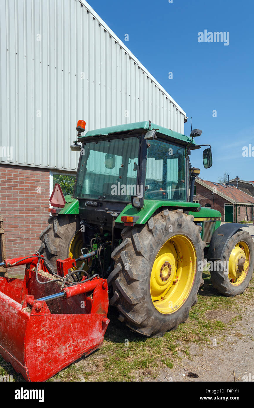 Modern Tractor at Traditional Holland Farm Stock Photo - Alamy