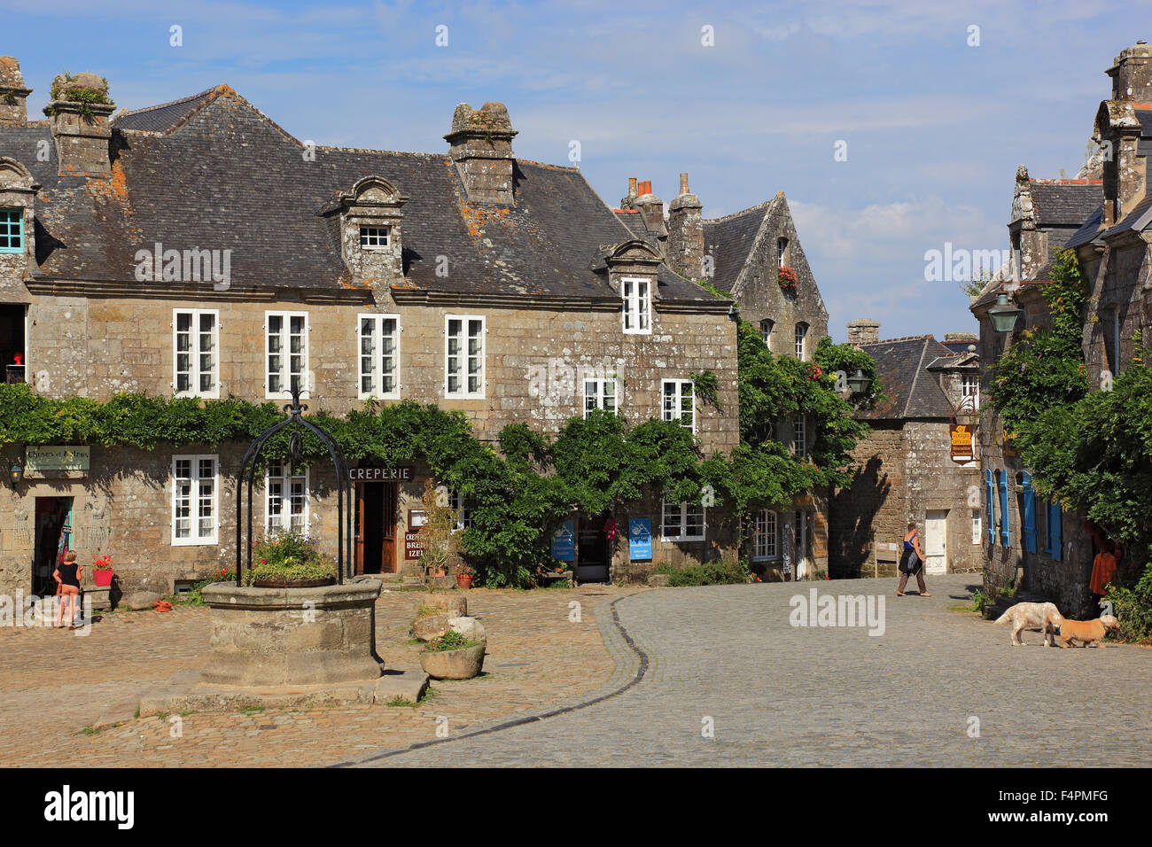 France, Brittany, houses in the medieval village Locronan, Fountain on ...