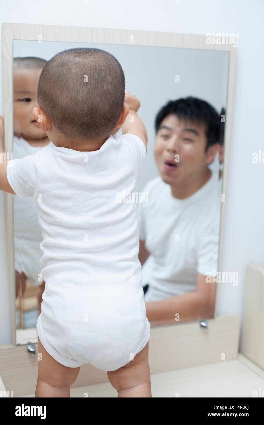Father and son looking in mirror hi-res stock photography and images ...