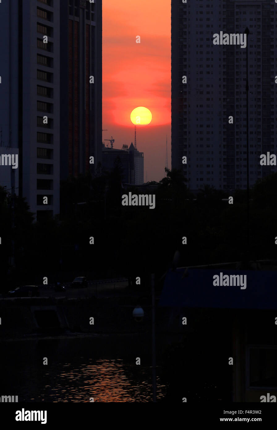 Views of the sun between buildings in the city of Jakarta, Indonesia ...