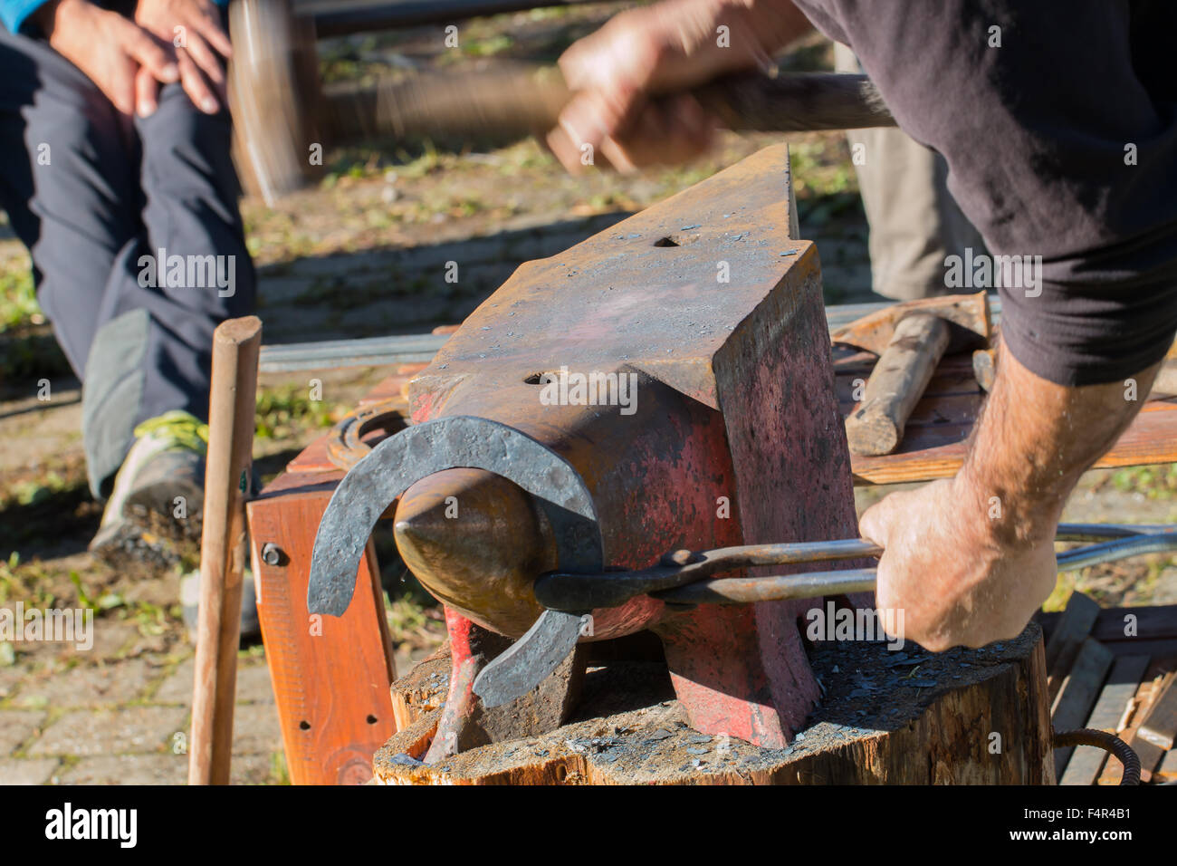 Blacksmith hammer quickly and hard on red hot horse shoe on anvil Stock ...